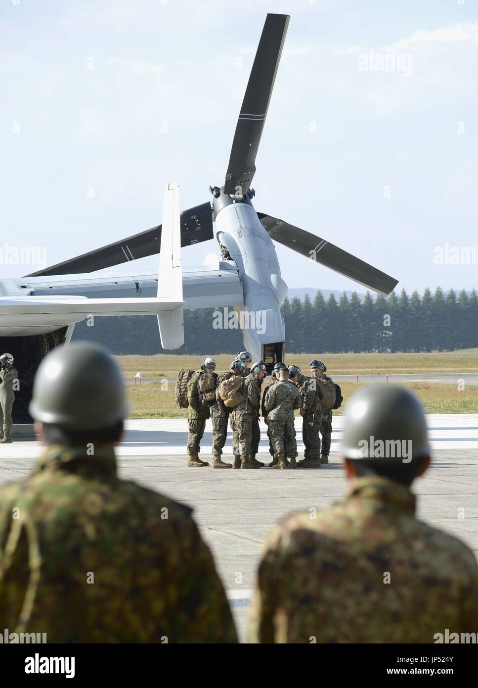 SENDAI, Japan - U.S. soldiers gather before an MV-22 Osprey aircraft ...