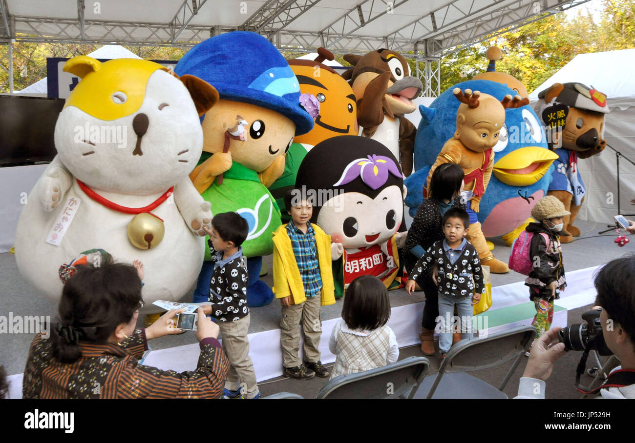 KOFU, Japan - Children pose for photographs with local mascots during ...