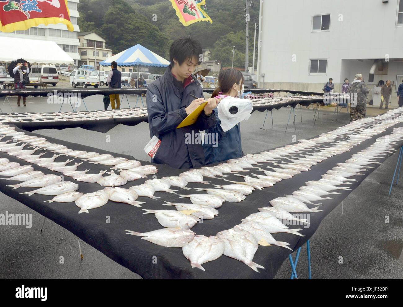 TOBA, Japan - Persons in charge of measuring the length of a line of ...
