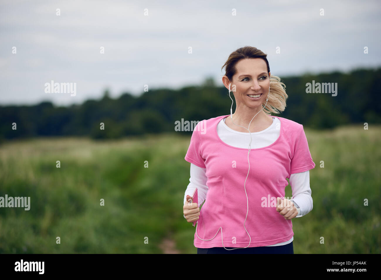 Woman running through field hi-res stock photography and images - Alamy