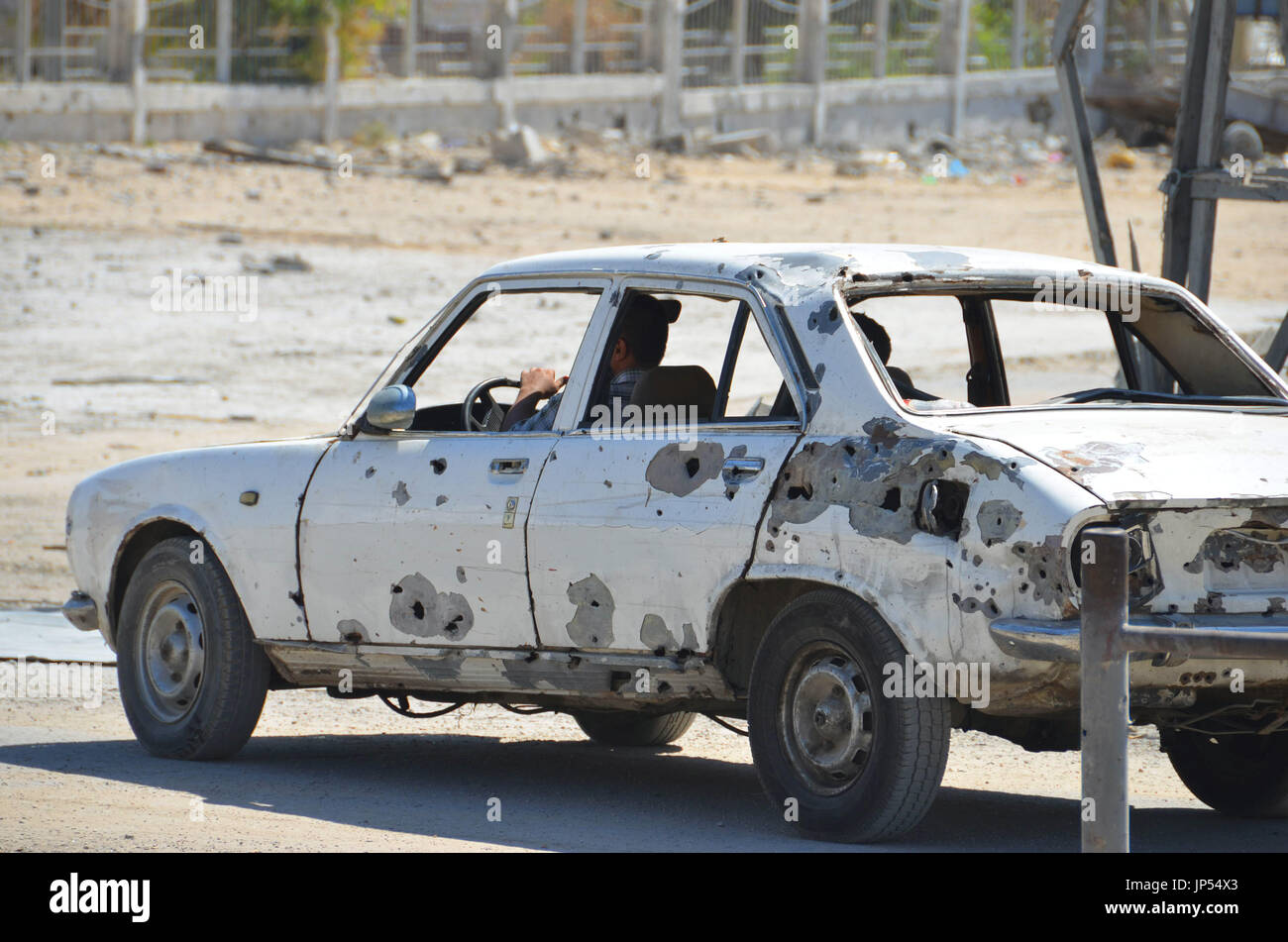 GAZA, Palestine Autonomous Region - A heavily damaged car drives ...