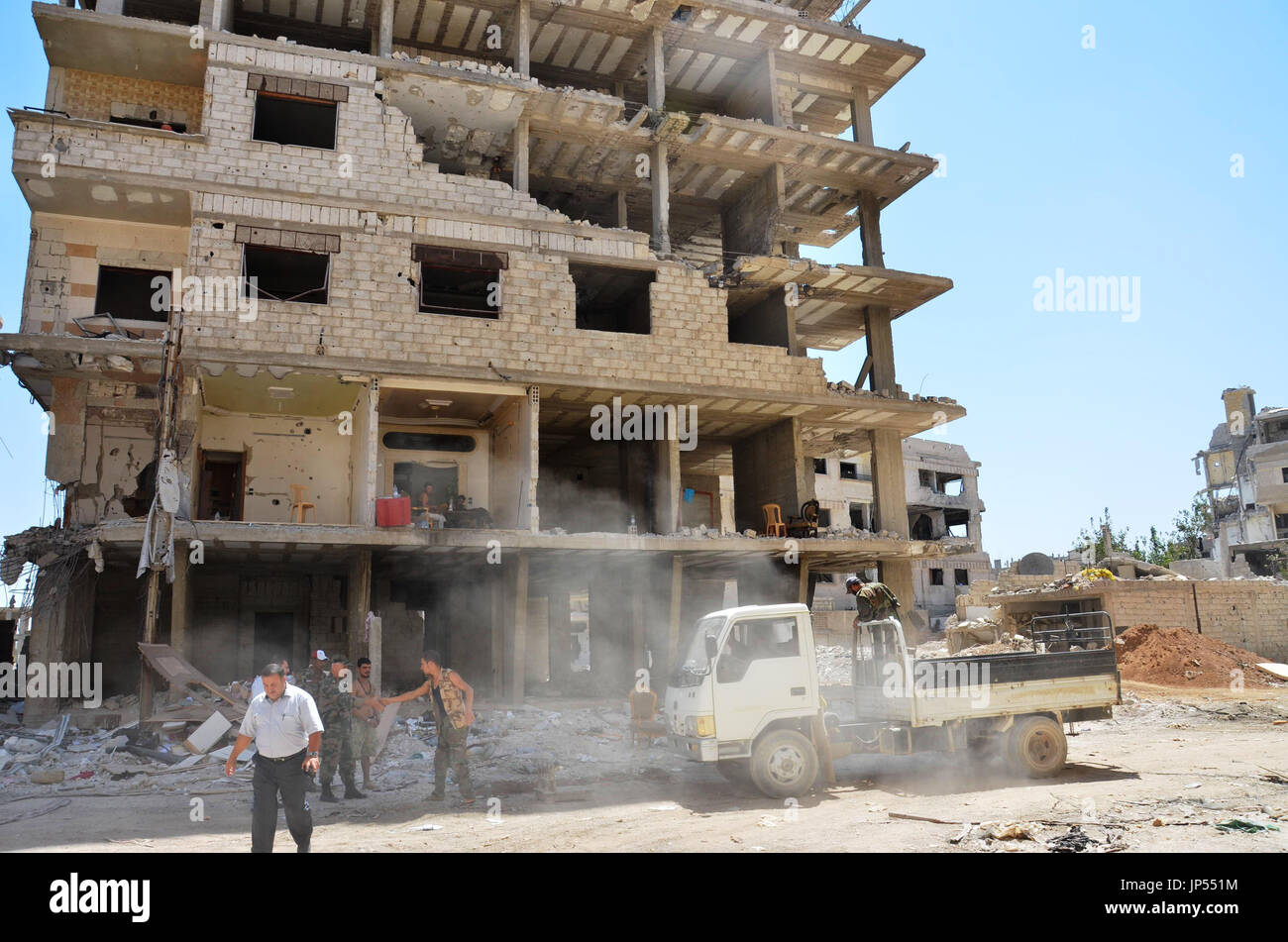 DAMASCUS, Syria - A building stands in ruins in the Damascus suburb of ...
