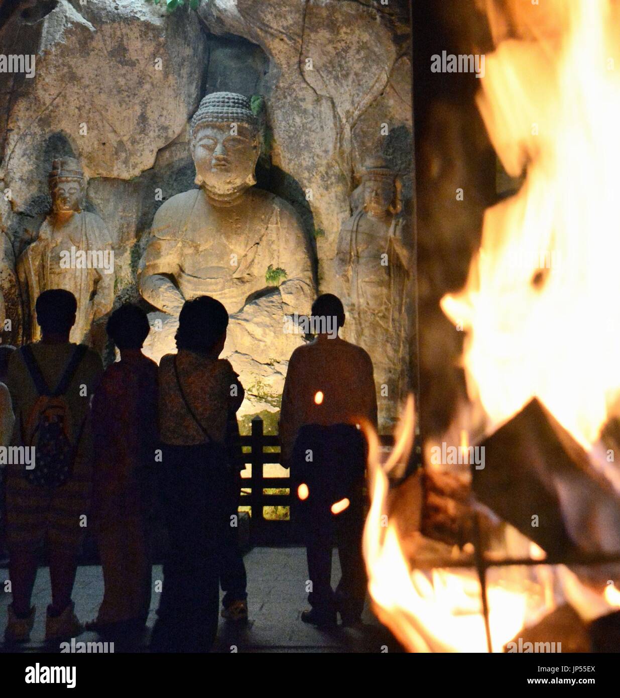 USUKI, Japan - Visitors view stone Buddha sculptures under the light of ...