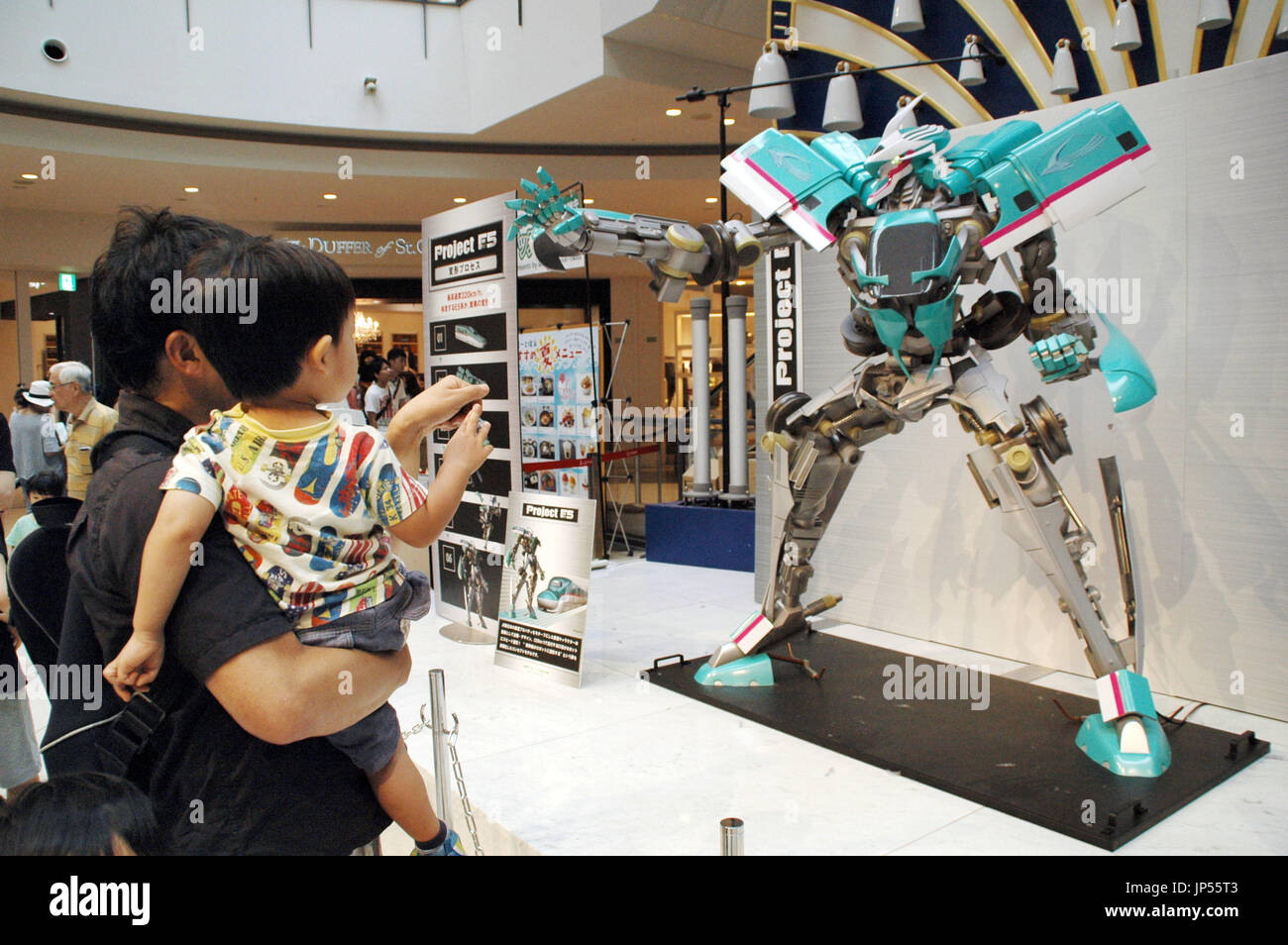 TOKYO, Japan - Visitors look at a transformer robot produced by East ...