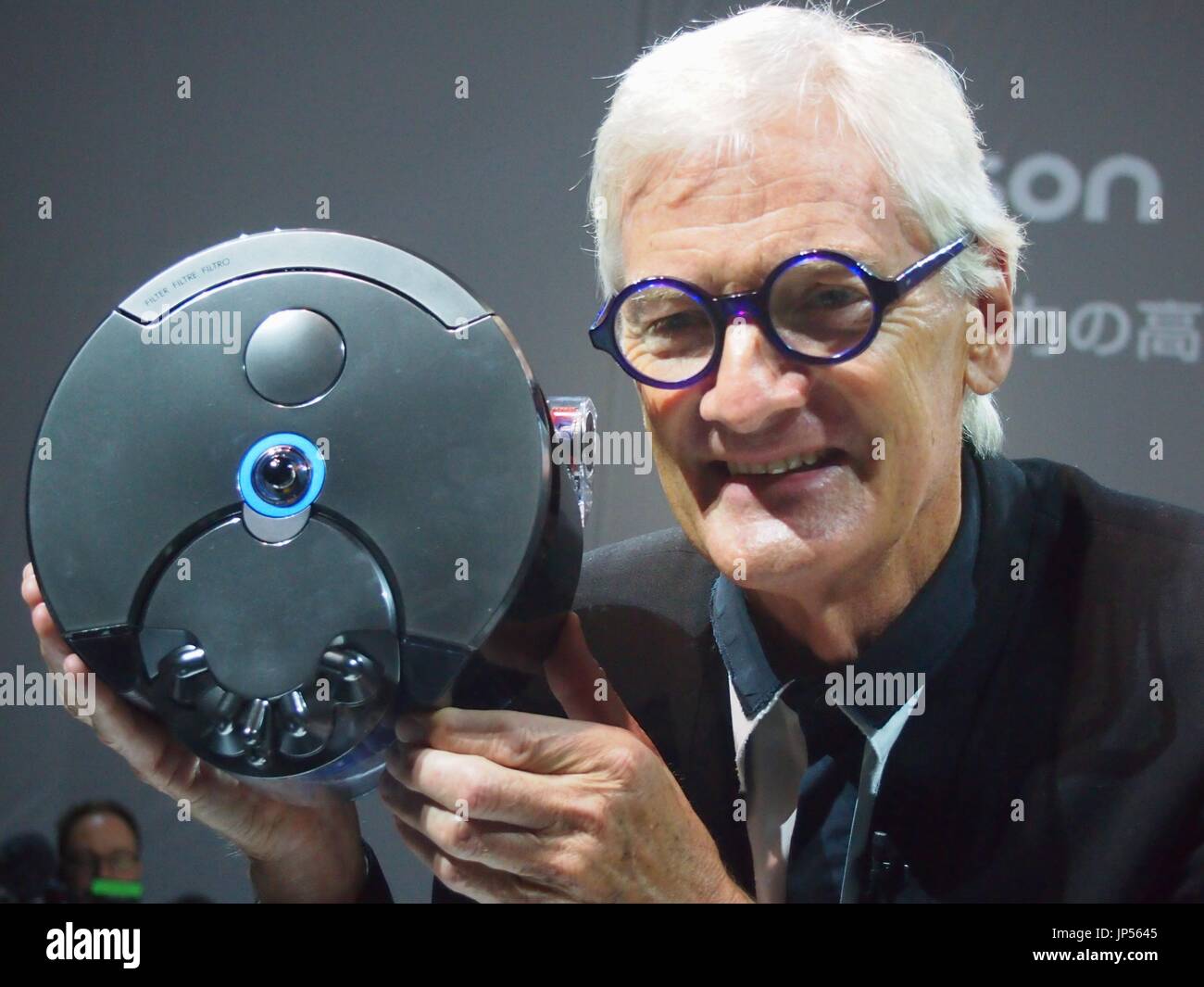 TOKYO, Japan - Dyson Ltd. founder James Dyson holds up a new autonomous ...
