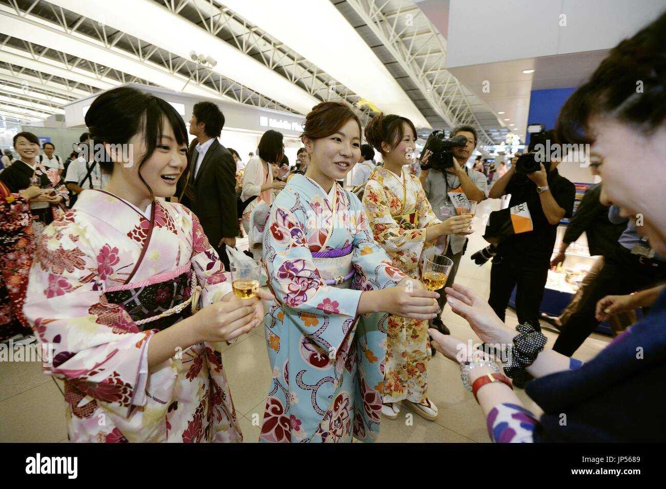 OSAKA, Japan - Women clad in kimono serve "umeshu" plum wine to ...