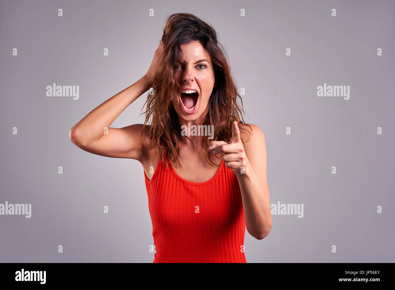 A beautiful young woman screaming furiously Stock Photo - Alamy