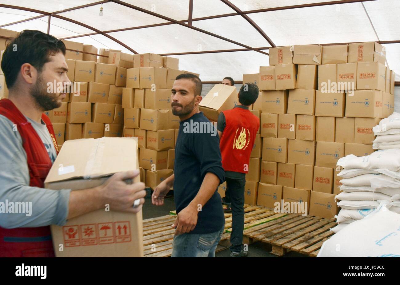 DAMASCUS, Syria - Workers bring relief goods into the U.N. World Food ...