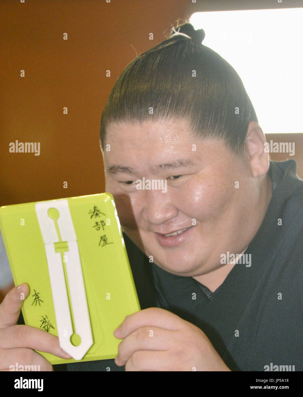 KOGA, Japan - Mongolian sumo wrestler Ichinojo looks into a mirror ...