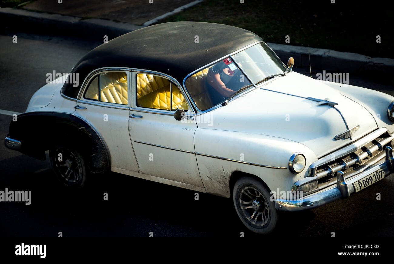High angle shot of a classic 1950s car driving on a road Stock Photo ...