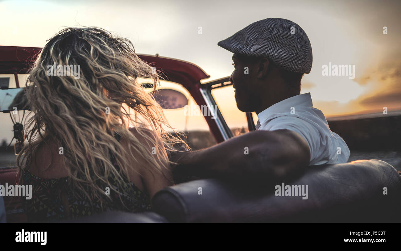Two people riding in an open convertible classic car Stock Photo - Alamy