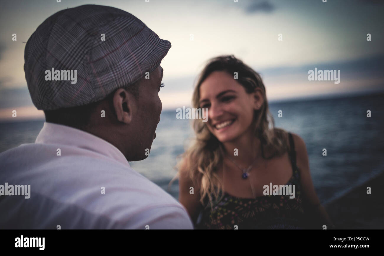 Two people facing each other in front of the ocean Stock Photo - Alamy