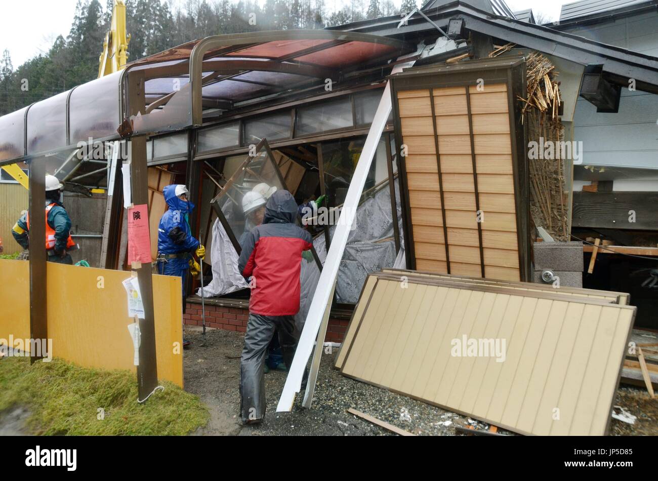 NAGANO, Japan - Volunteers help demolish a damaged house in Hakuba, one ...