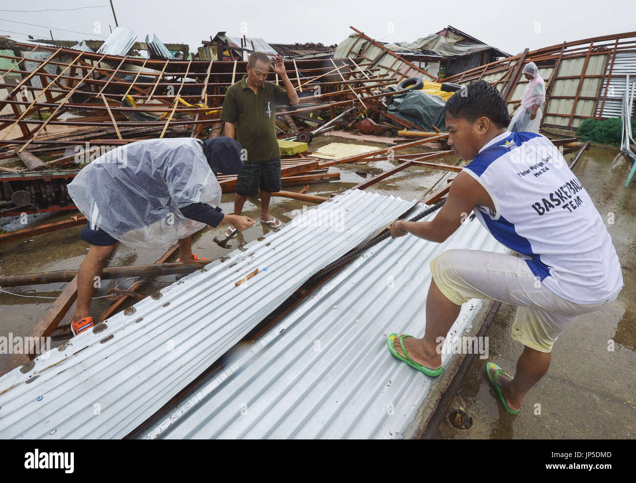 TACLOBAN, Philippines - Residents remove corrugated metal from a roof ...