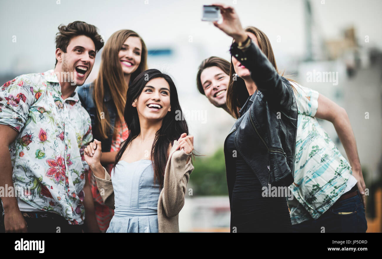 Five people standing with their arms raised hi-res stock photography ...