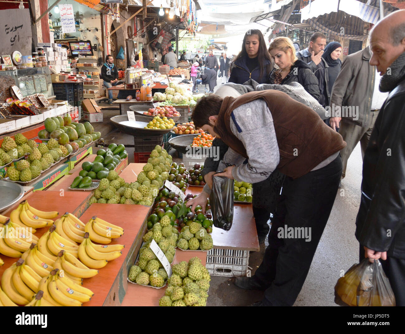 DAMASCUS, Syria - People buy fruits at a fresh food market in Damascus ...