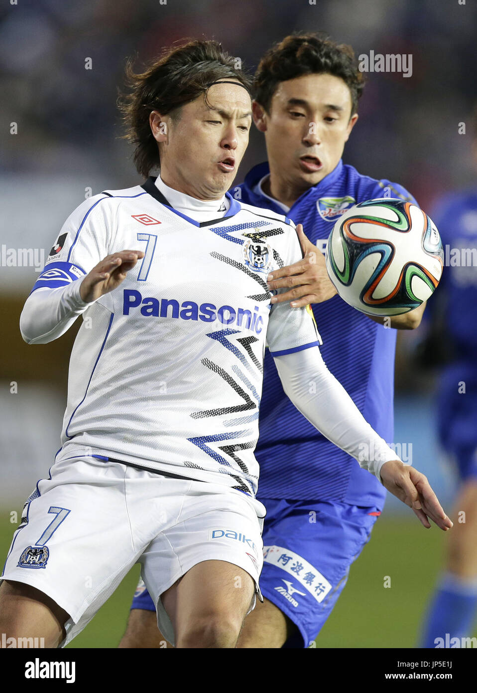 TOKUSHIMA, Japan - Yasuhito Endo (front) of Gamba Osaka and Yuya Hashiuchi of Tokushima Vortis ...