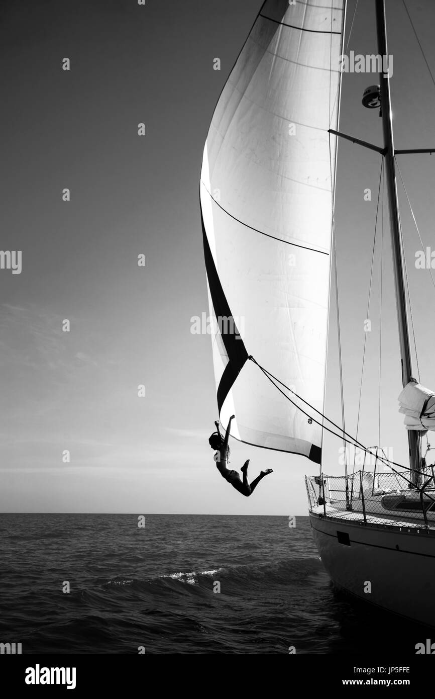 Woman jumping from a yacht into the ocean Stock Photo - Alamy
