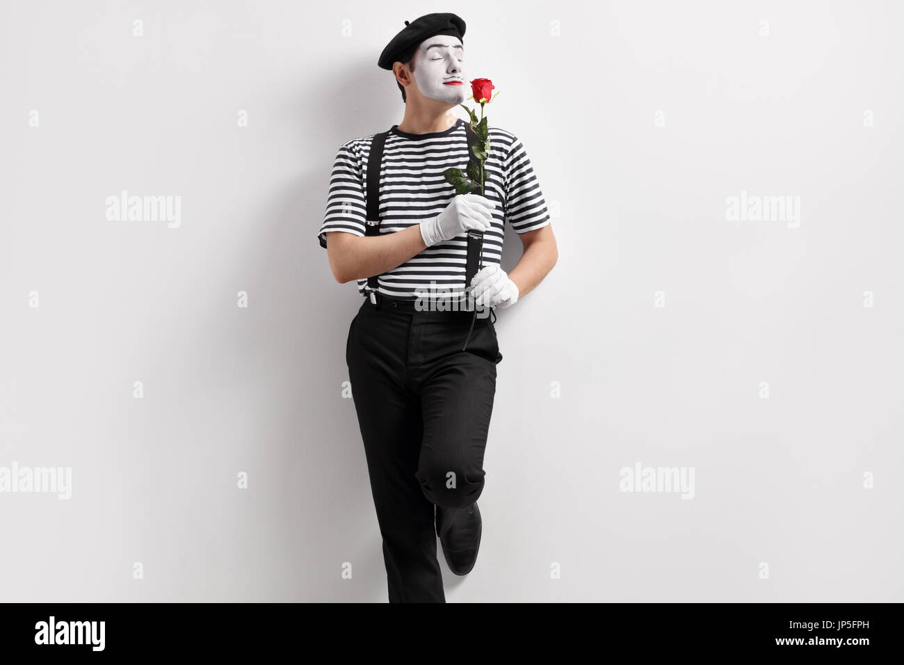 Mime artist smelling a flower and leaning against a wall Stock Photo ... Mime artist smelling a flower and leaning against a wall Stock Photo ...