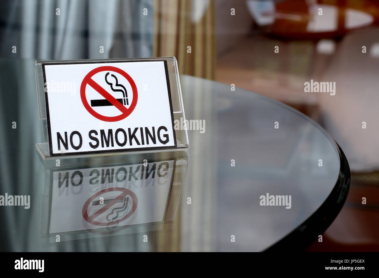 photo of no smoking sign on glass table Stock Photo - Alamy