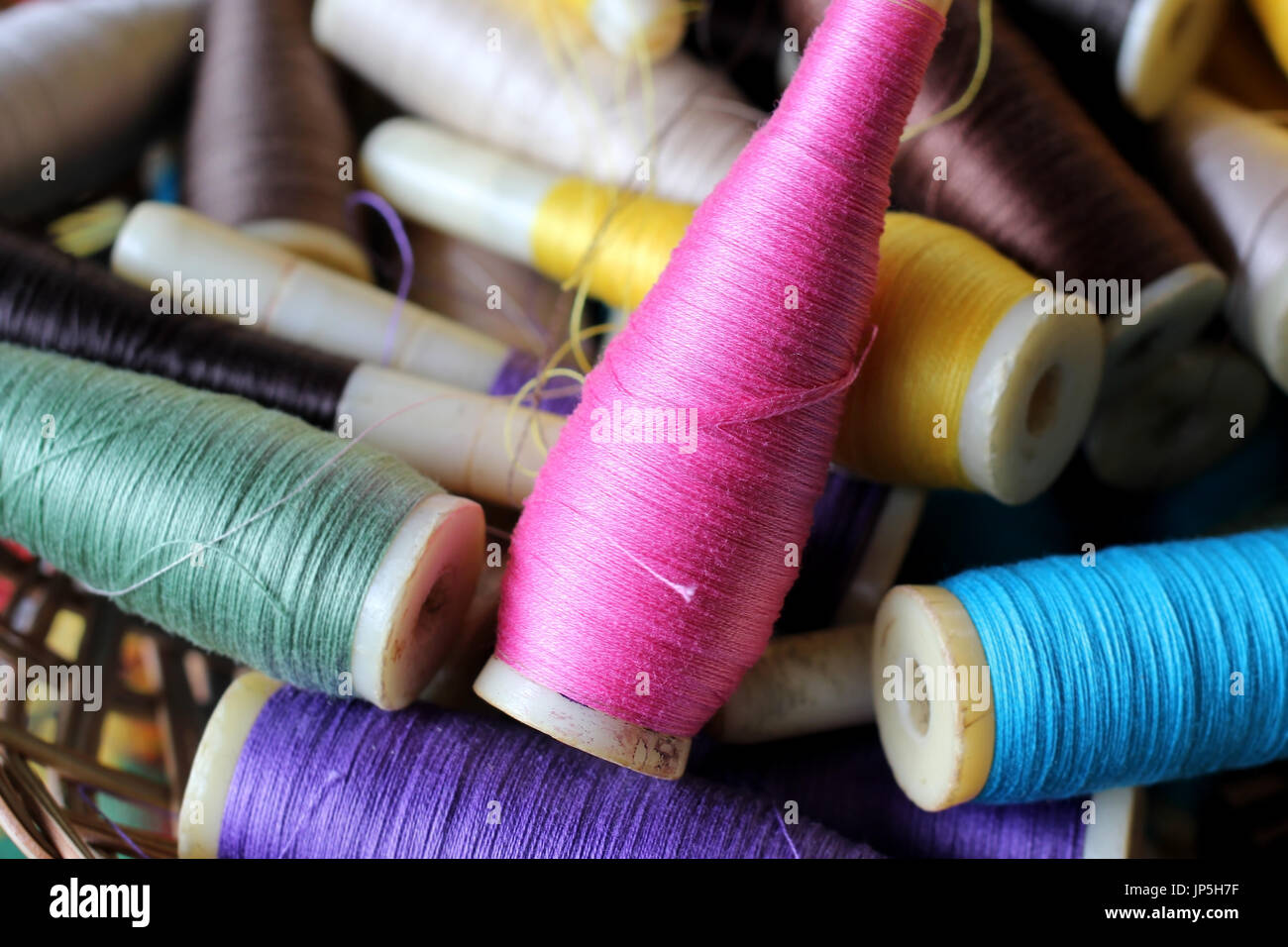 colorful bobbins of thread in basket Stock Photo - Alamy