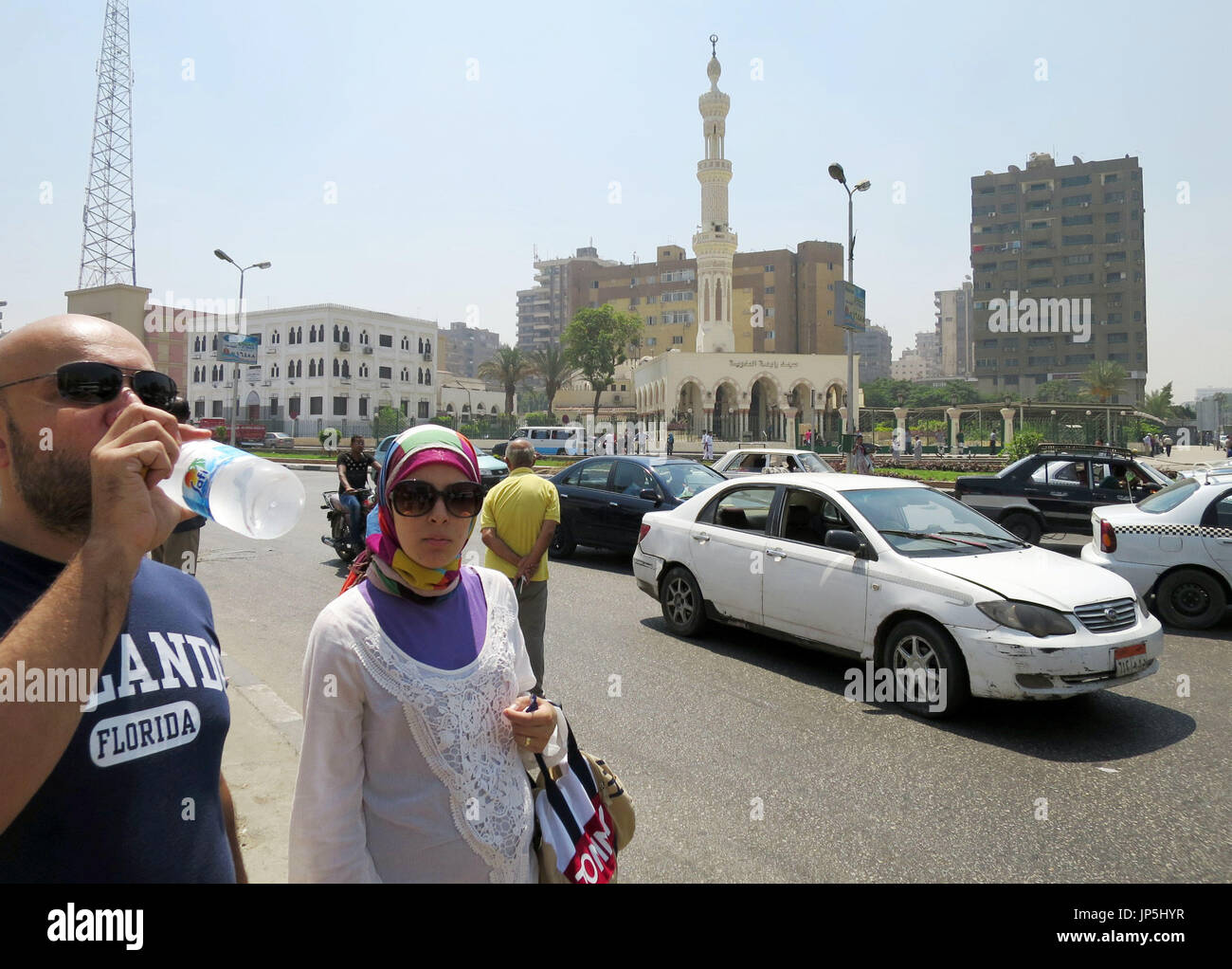 CAIRO, Egypt - Egyptian citizens walk near the intersection of Cairo's ...