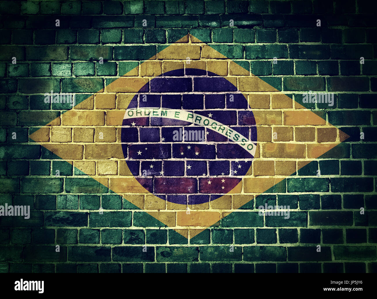 Faded Brazilian flag on a brick wall background with a dark vignette ...