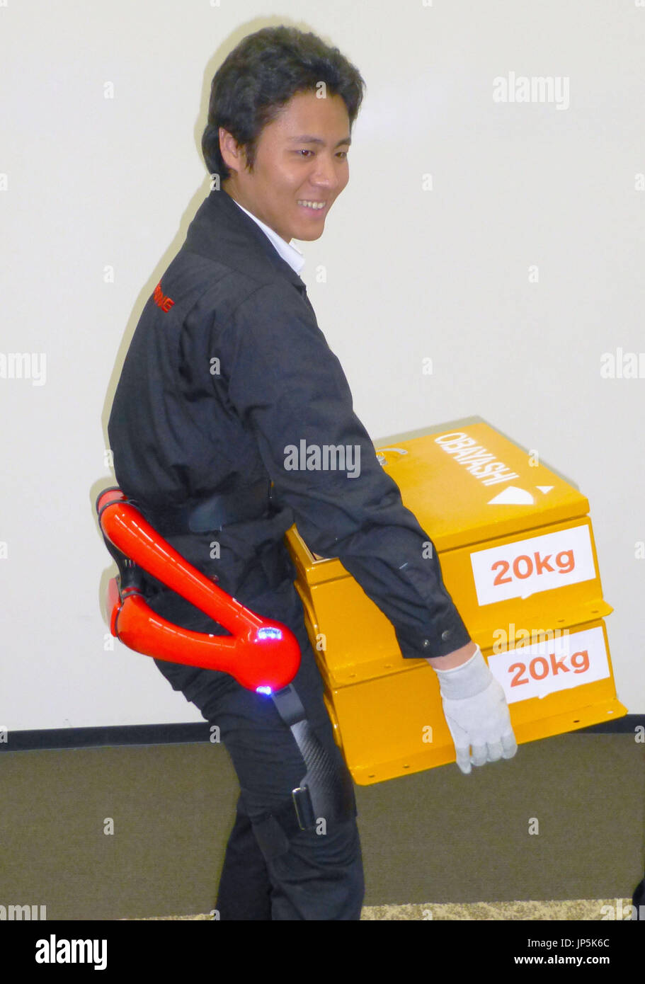 TSUKUBA, Japan - A man wears the new HAL (Hybrid Assistive Limb) robot ...