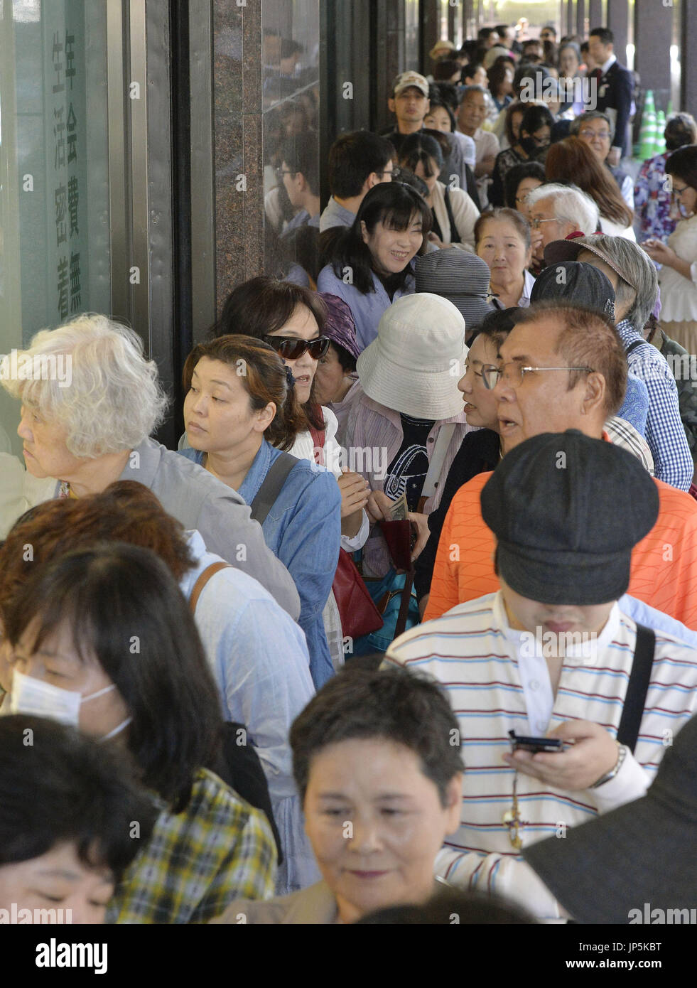FUKUOKA, Japan - People line up outside the Daimaru department store in ...