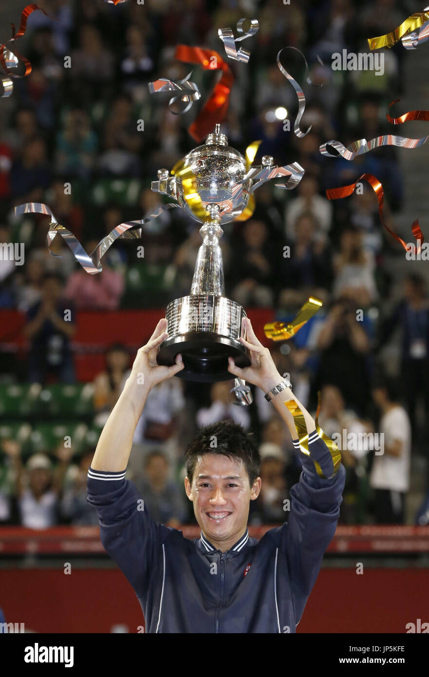 TOKYO, Japan - Kei Nishikori of Japan holds up the winner's trophy ...