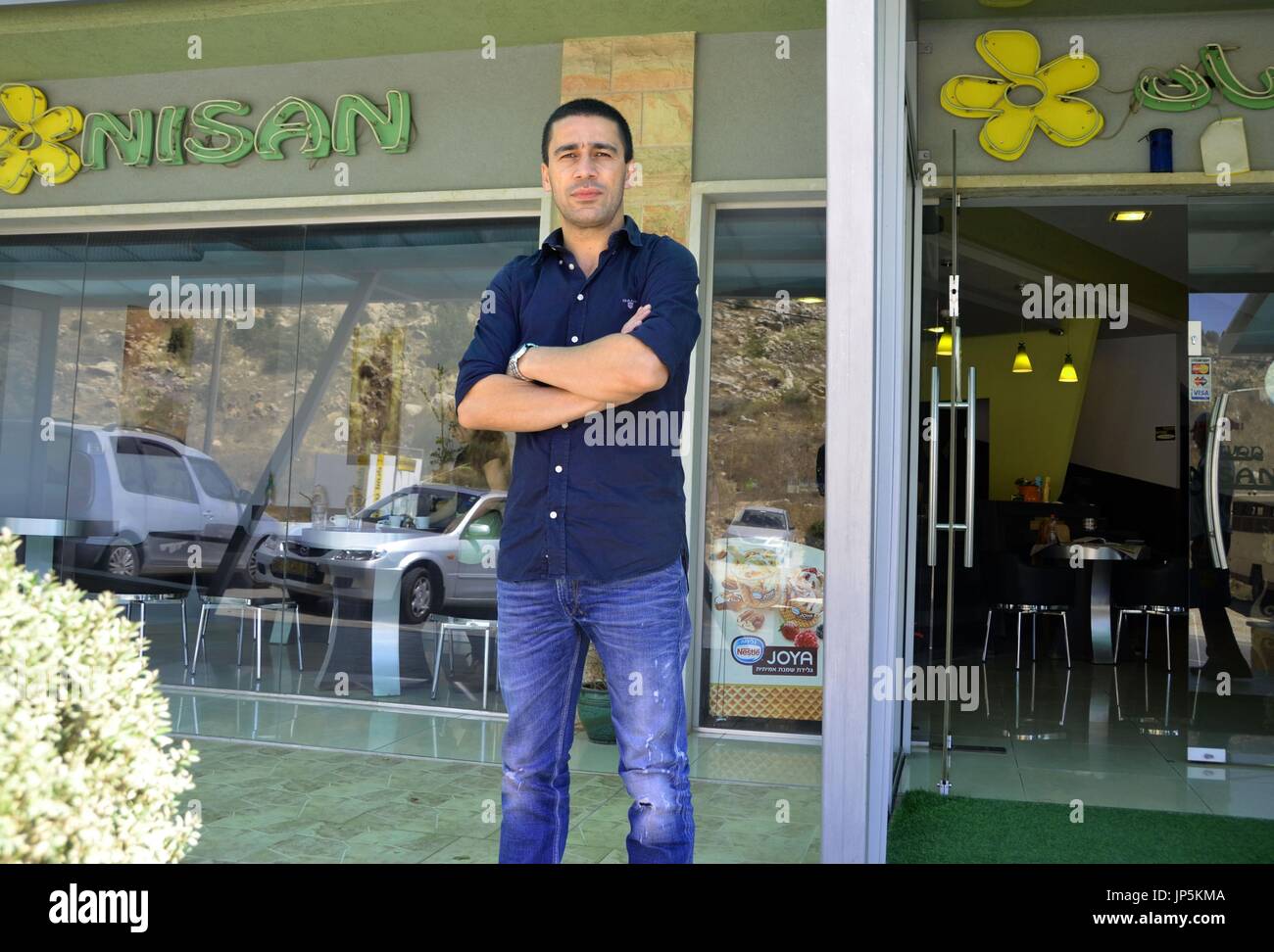 MAJDAL SHAMS, Golan Heights - A restaurateur stands in front of his ...