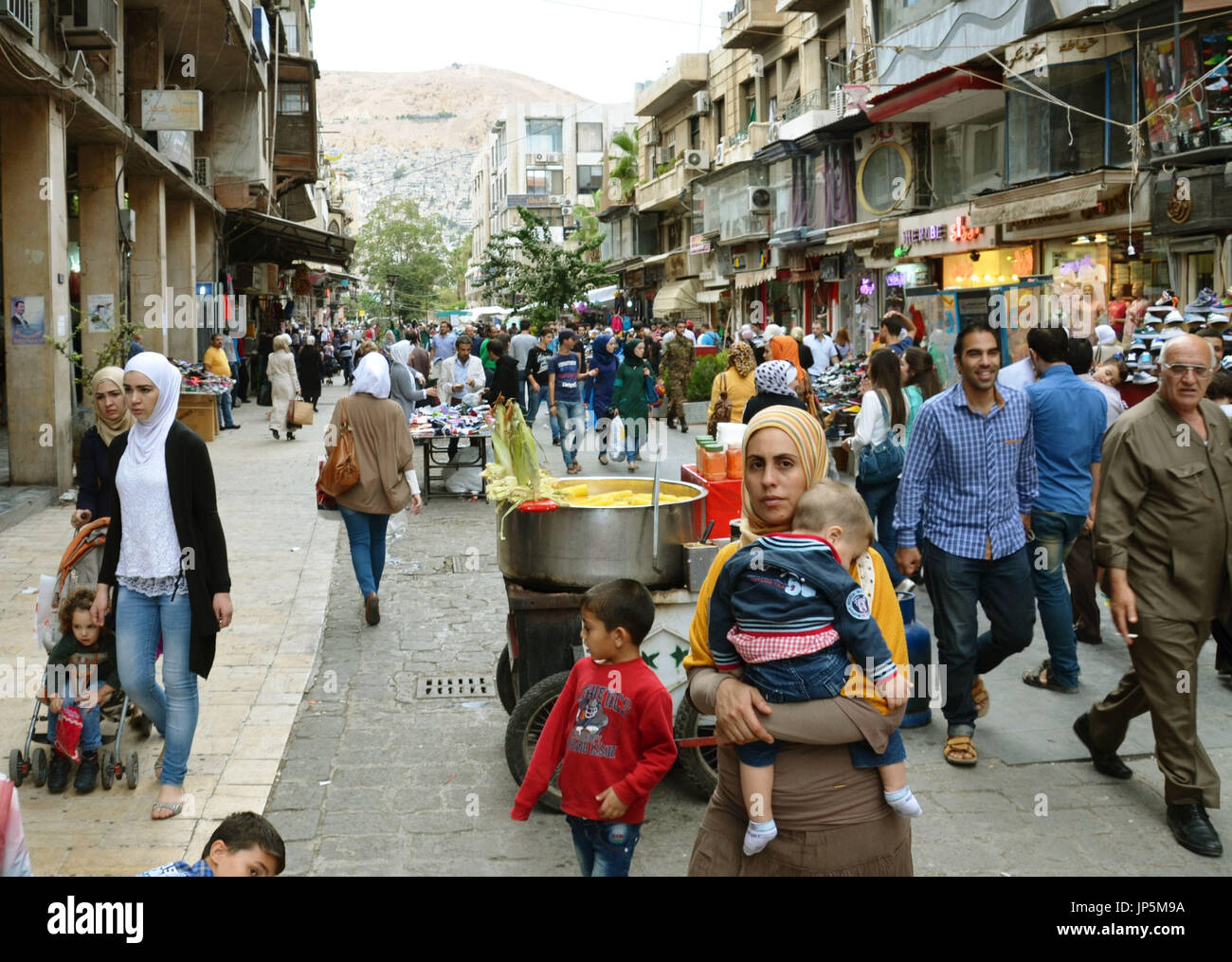 DAMASCUS, Syria - People stroll on a shopping street in Damascus in ...