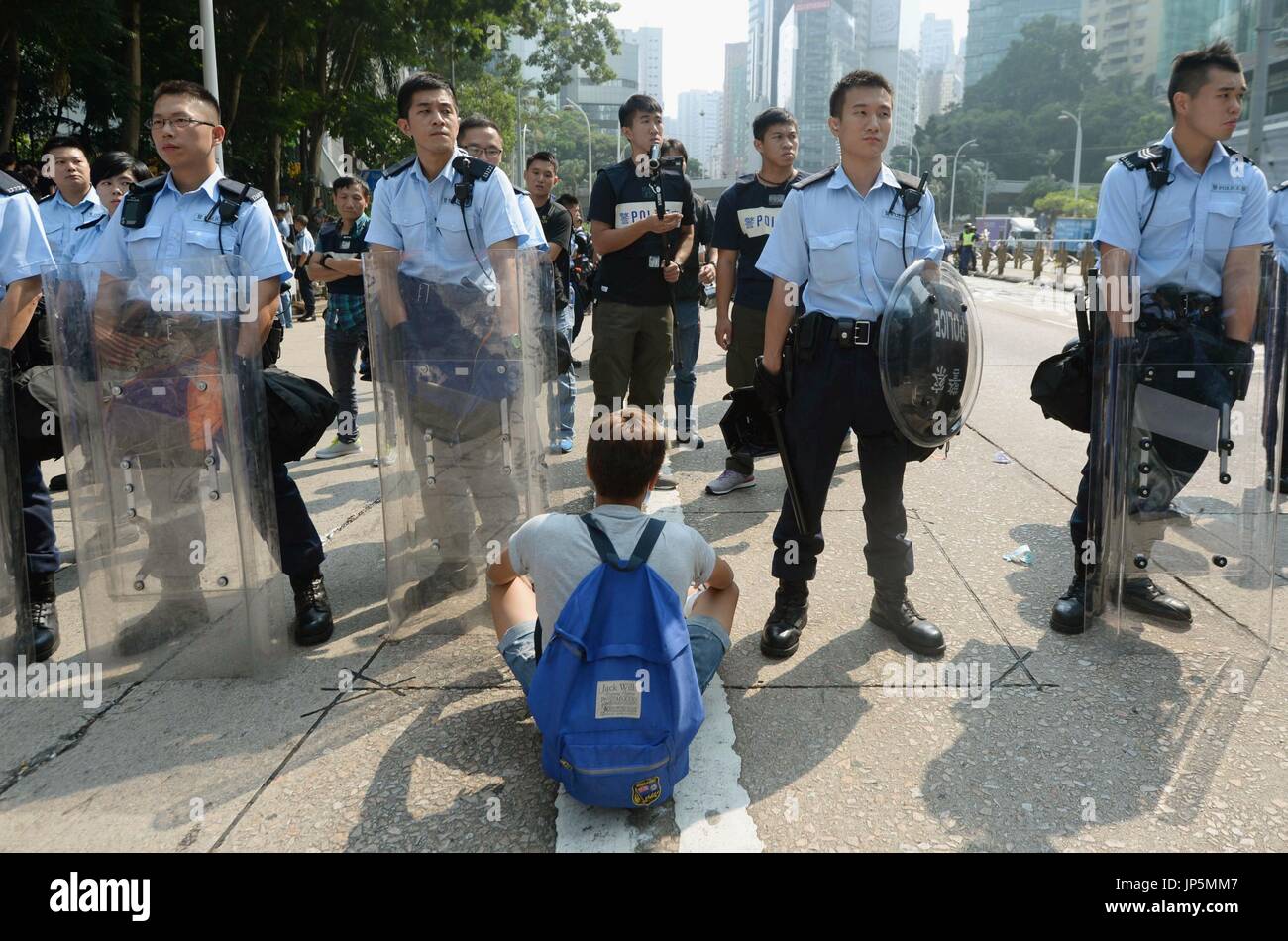 HONG KONG, China - A pro-democracy protester sits on a road in front of ...