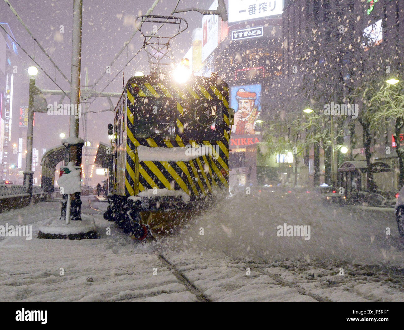SAPPORO, Japan - A snow plow known as the "Sasara tram" is at work on a ...