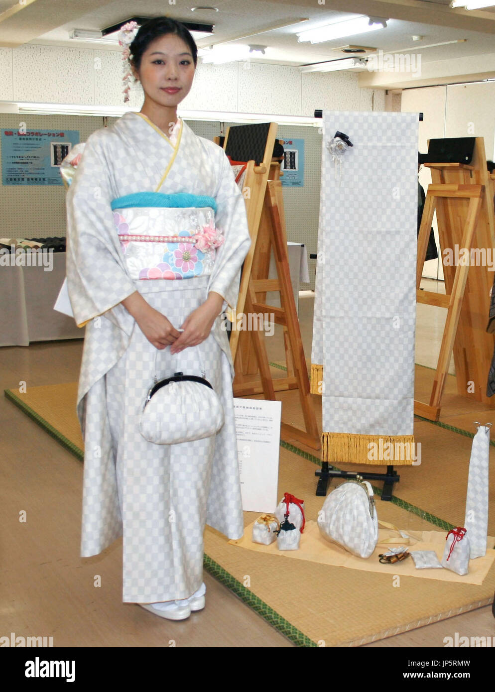 AMAMI, Japan - A model wears a kimono made of white "Oshima tsumugi ...