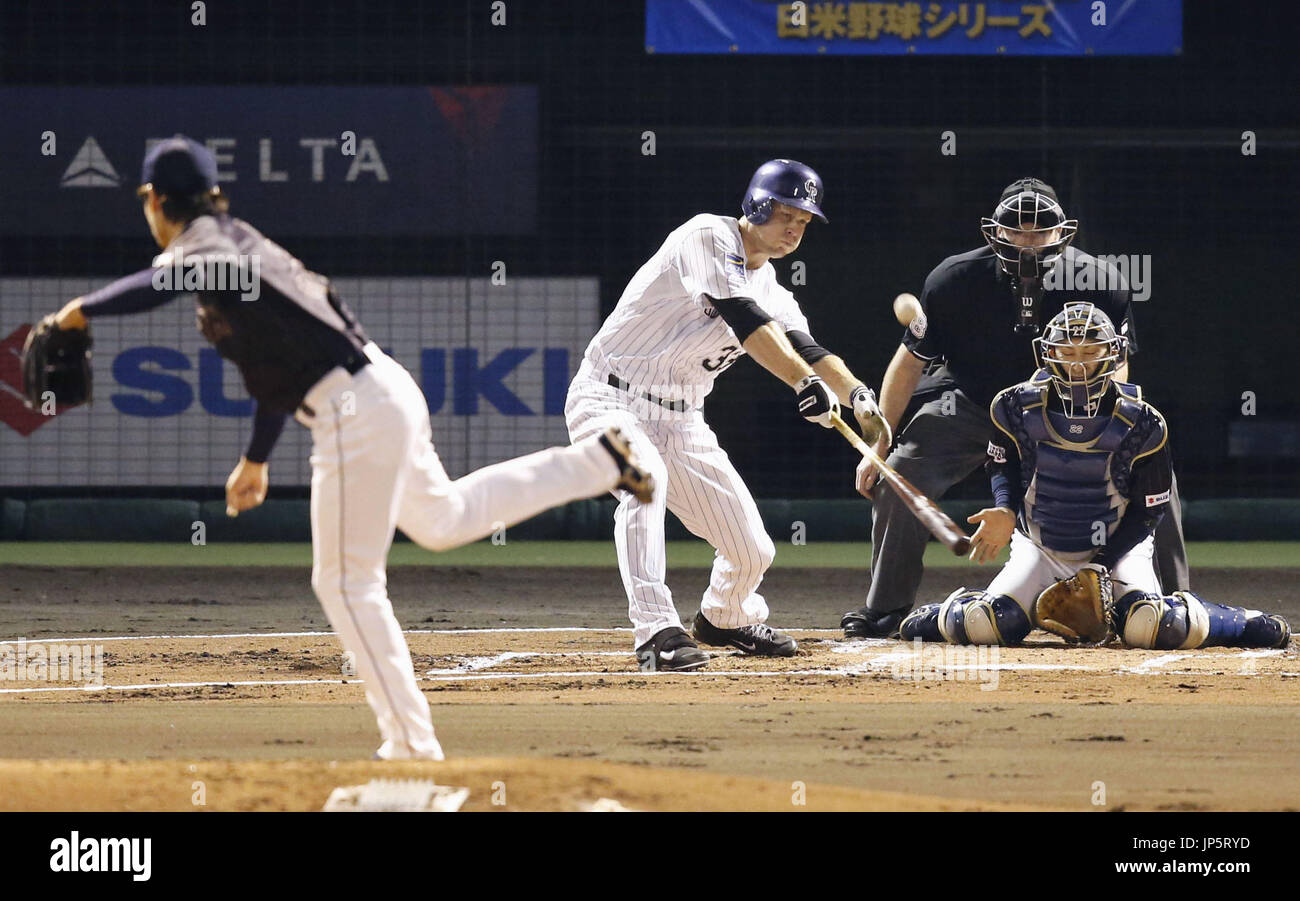 NAHA, Japan - The MLB All-Stars Justin Morneau hits a sacrifice fly off ...