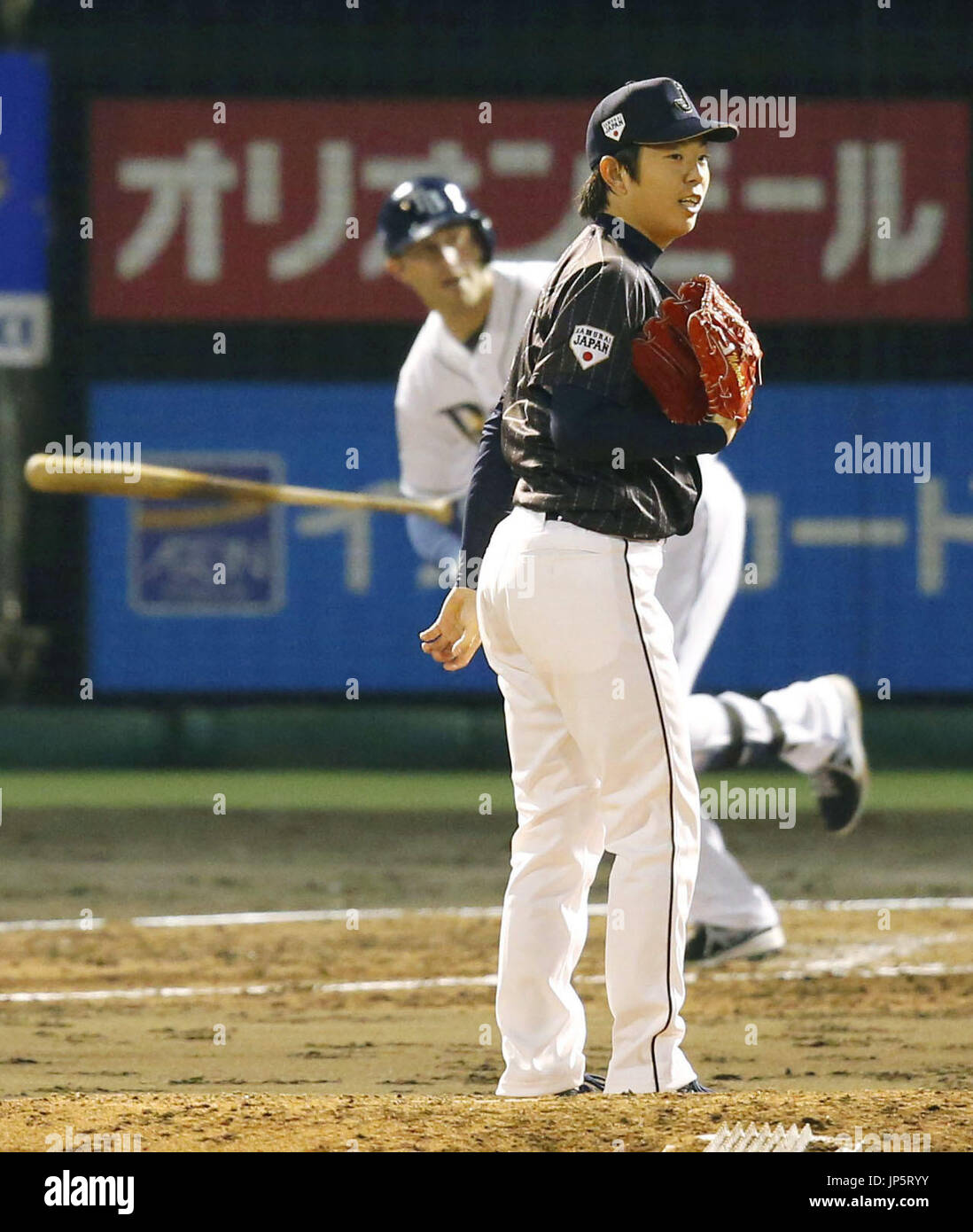 NAHA, Japan - Japan's pitcher Takahiro Matsuba watches a homer hit by ...