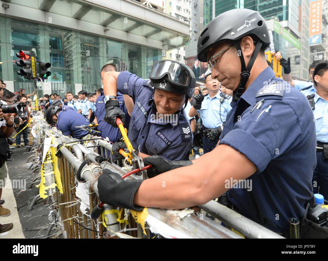 HONG KONG, China - Police officers dismantle barricades placed by pro ...