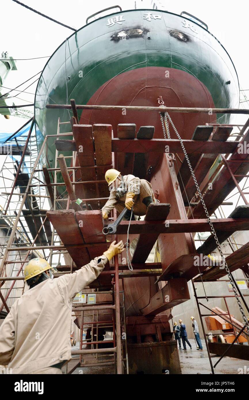 HIROSHIMA, Japan - Workers engage in ship-repair work at Sanwa Dock Co ...