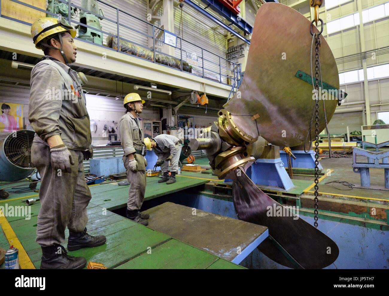 HIROSHIMA, Japan - Workers engage in ship-repair work at Sanwa Dock Co ...