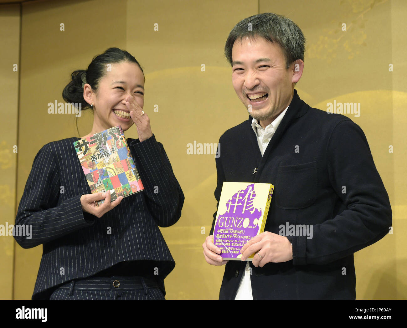 TOKYO, Japan - Kanako Nishi (L) and Masatsugu Ono smile while posing for photos at a hotel in ...