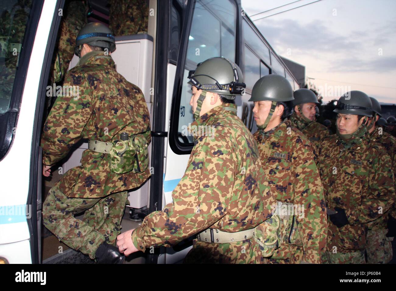 OKAYAMA, Japan - Self-Defense Forces personnel head to a chicken farm ...
