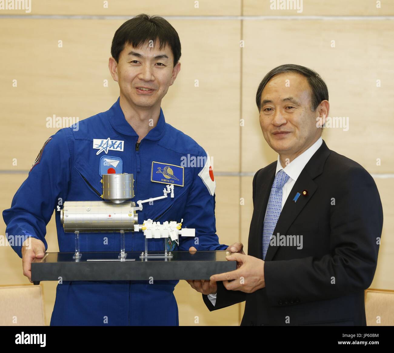 TOKYO, Japan - Astronaut Kimiya Yui holds a model of the Japanese ...