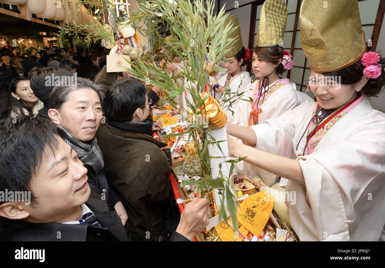 OSAKA, Japan - "Fuku musume," or good luck girls, clad in kimono and donning golden headwear ...