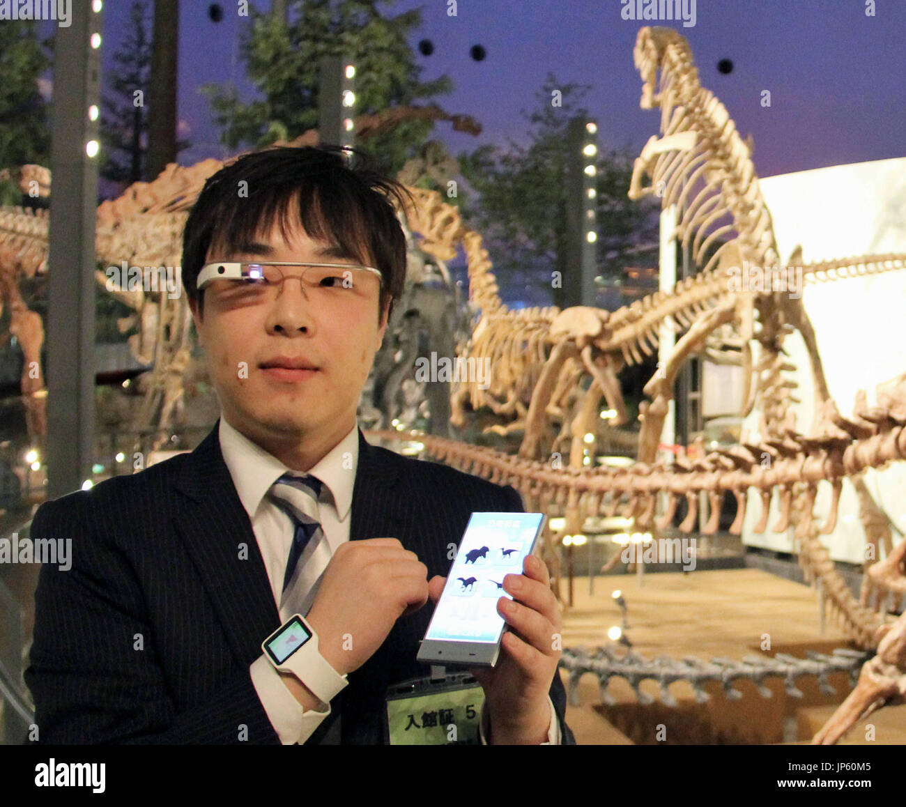 FUKUI, Japan - A Softbank Mobile Corp. official tests a wearable ...