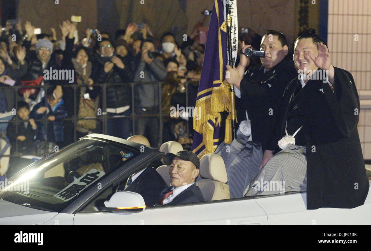 Yokozuna (grand champion) Hakuho of Mongolia (R) waves to sumo fans in ...
