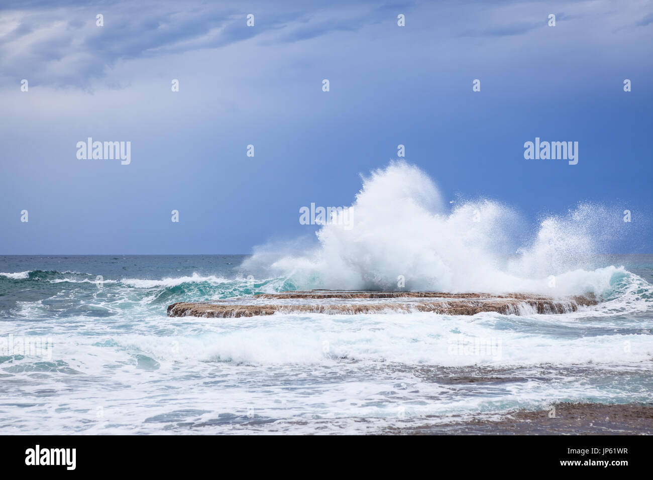 Waves crashing on rock Stock Photo - Alamy