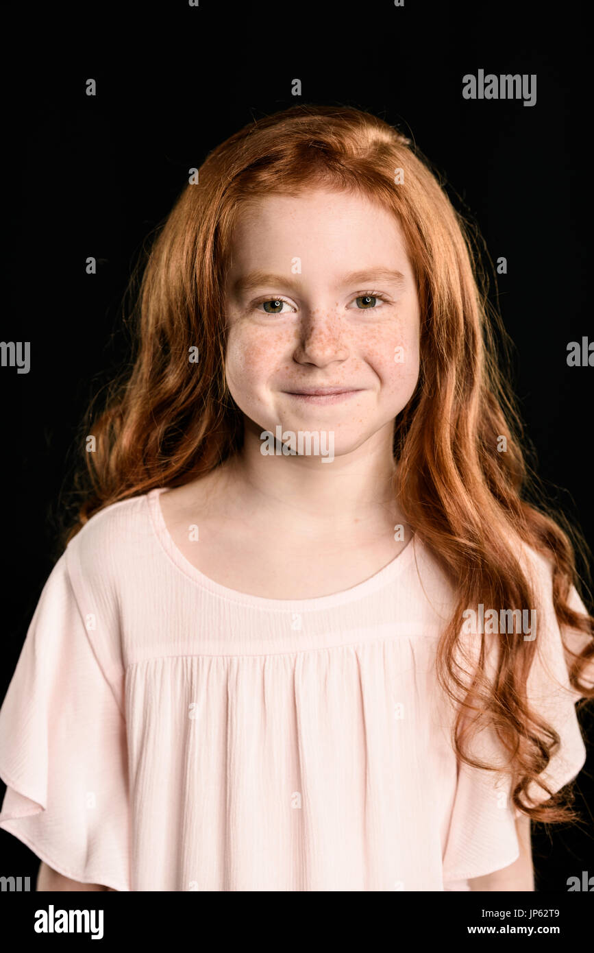 Portrait of adorable little redhead girl smiling at camera isolated on ...
