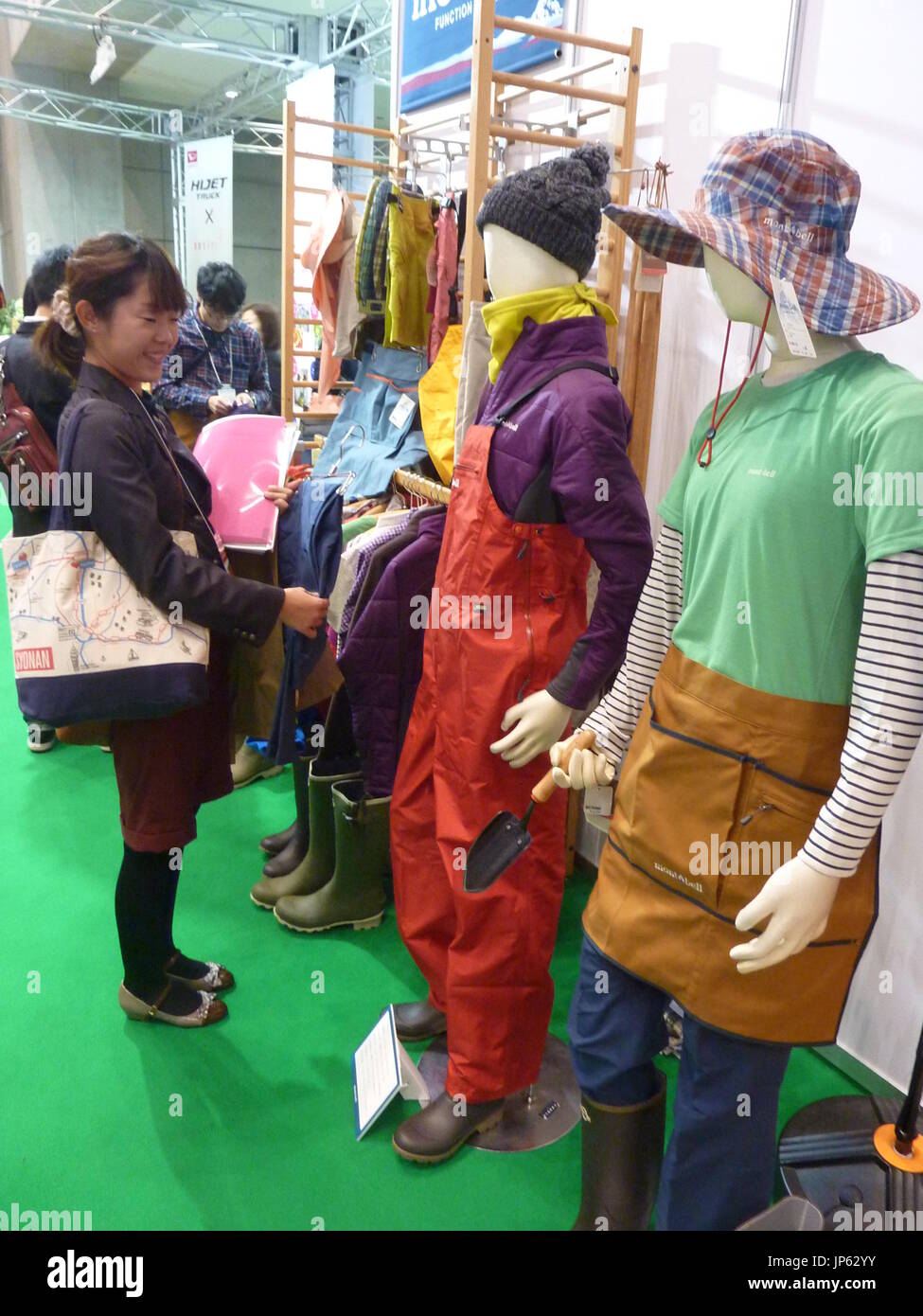 TOKYO, Japan - A female farmer looks at fashionable work outfits at an ...