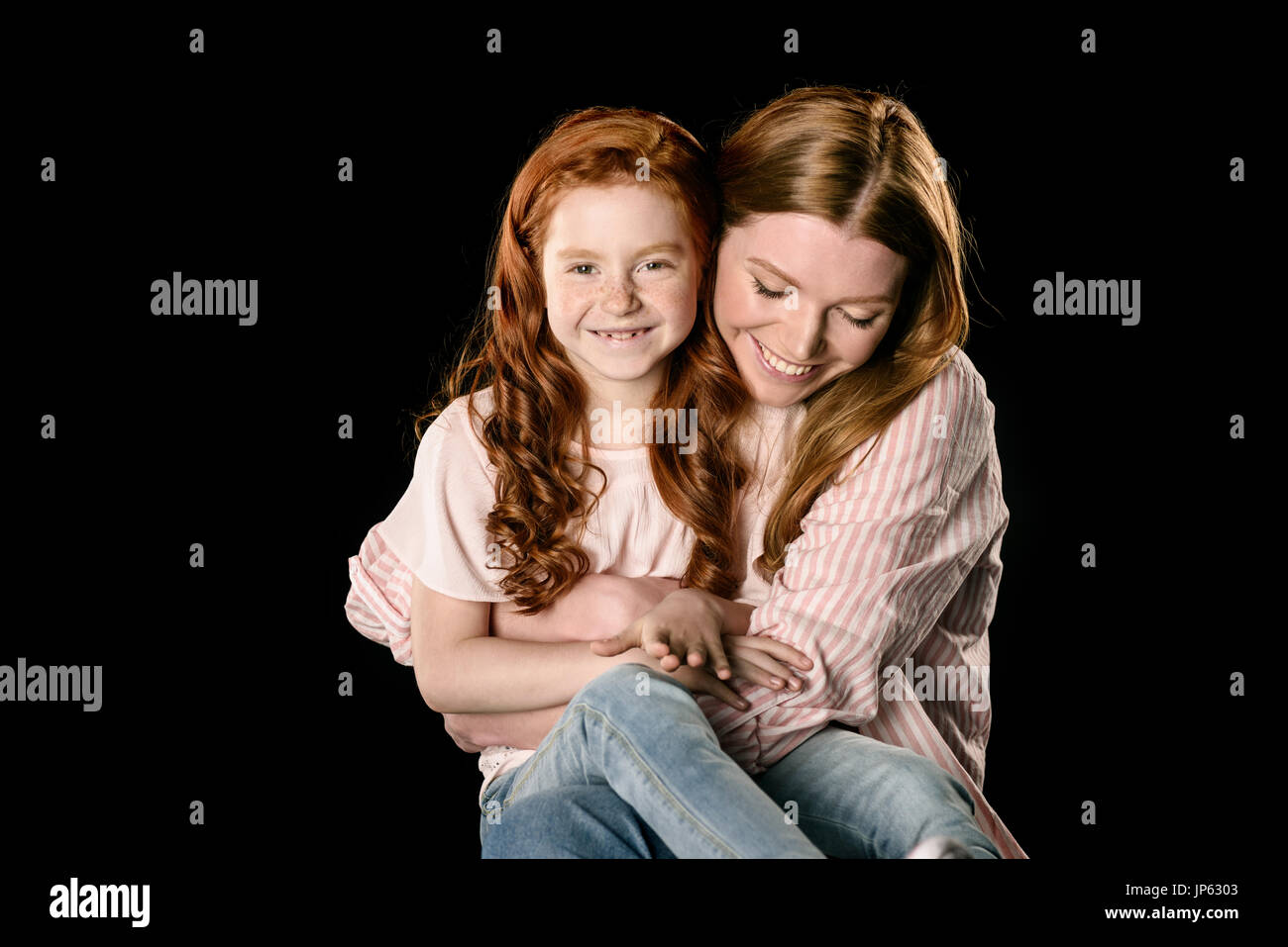 Beautiful Happy Redhead Mother And Daughter Embracing Isolated On Black